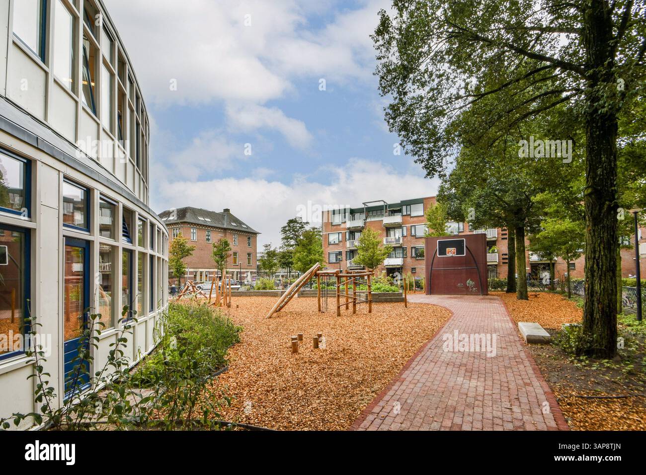 A view of a contemporary school playground surrounded by trees and ...
