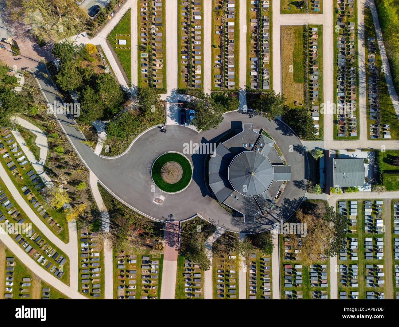 Aerial view of a cemetery with symmetrical rows of graves, a central ...