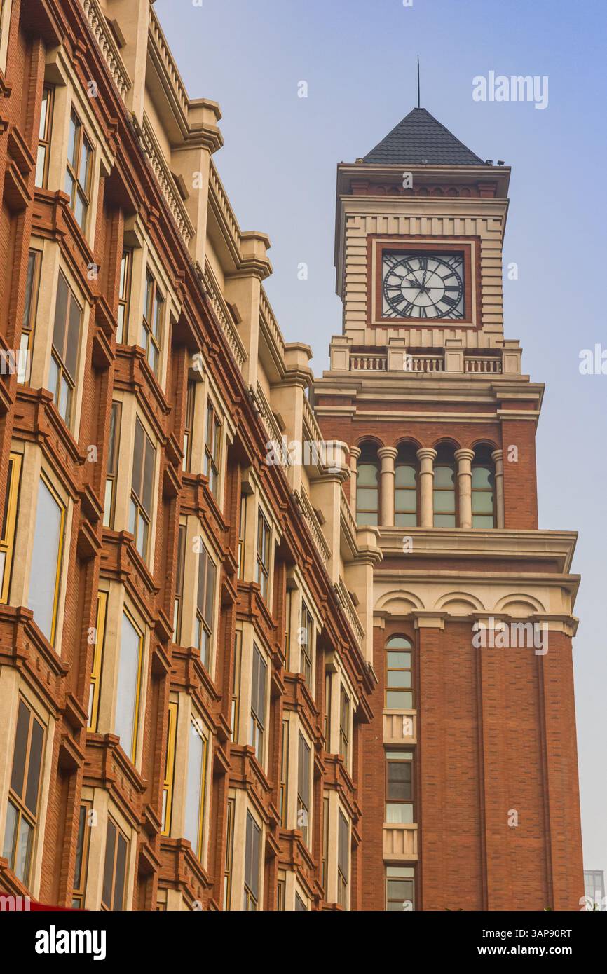 Clock tower of a historic apartment building in Tianjin, China Stock ...