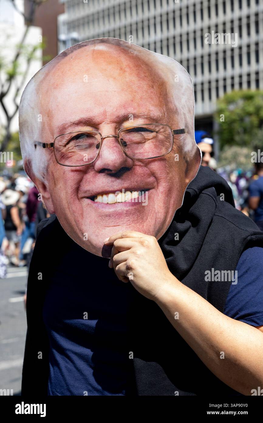 April 12, 2025: A person holds up a Bernie Sanders face cut out inside ...