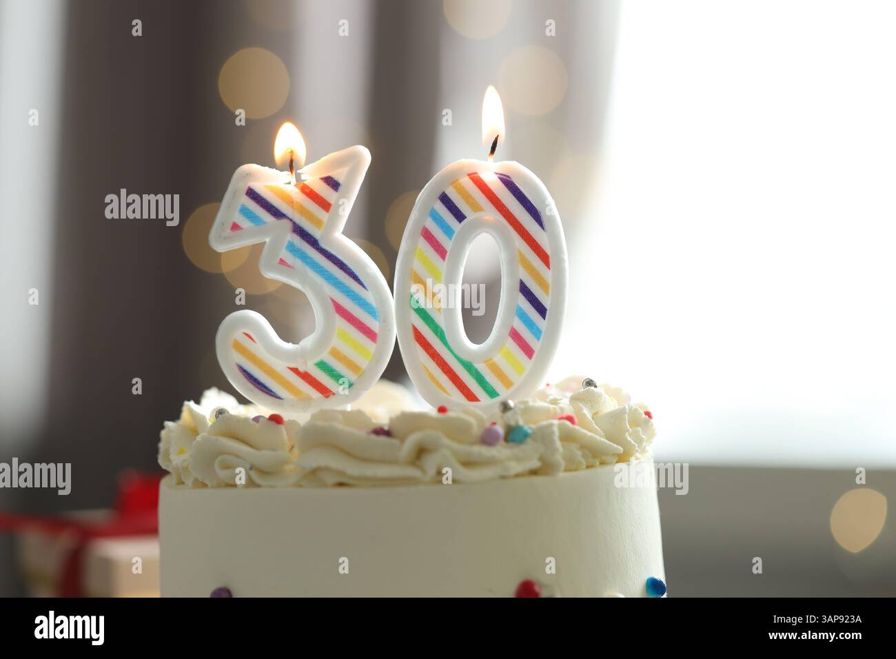 30th birthday. Tasty cake with burning number shaped candles and ...