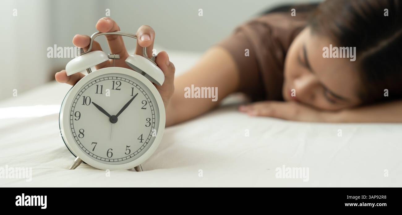 Lazy Asia young woman close a clock alarm, lady is late appointment or ...