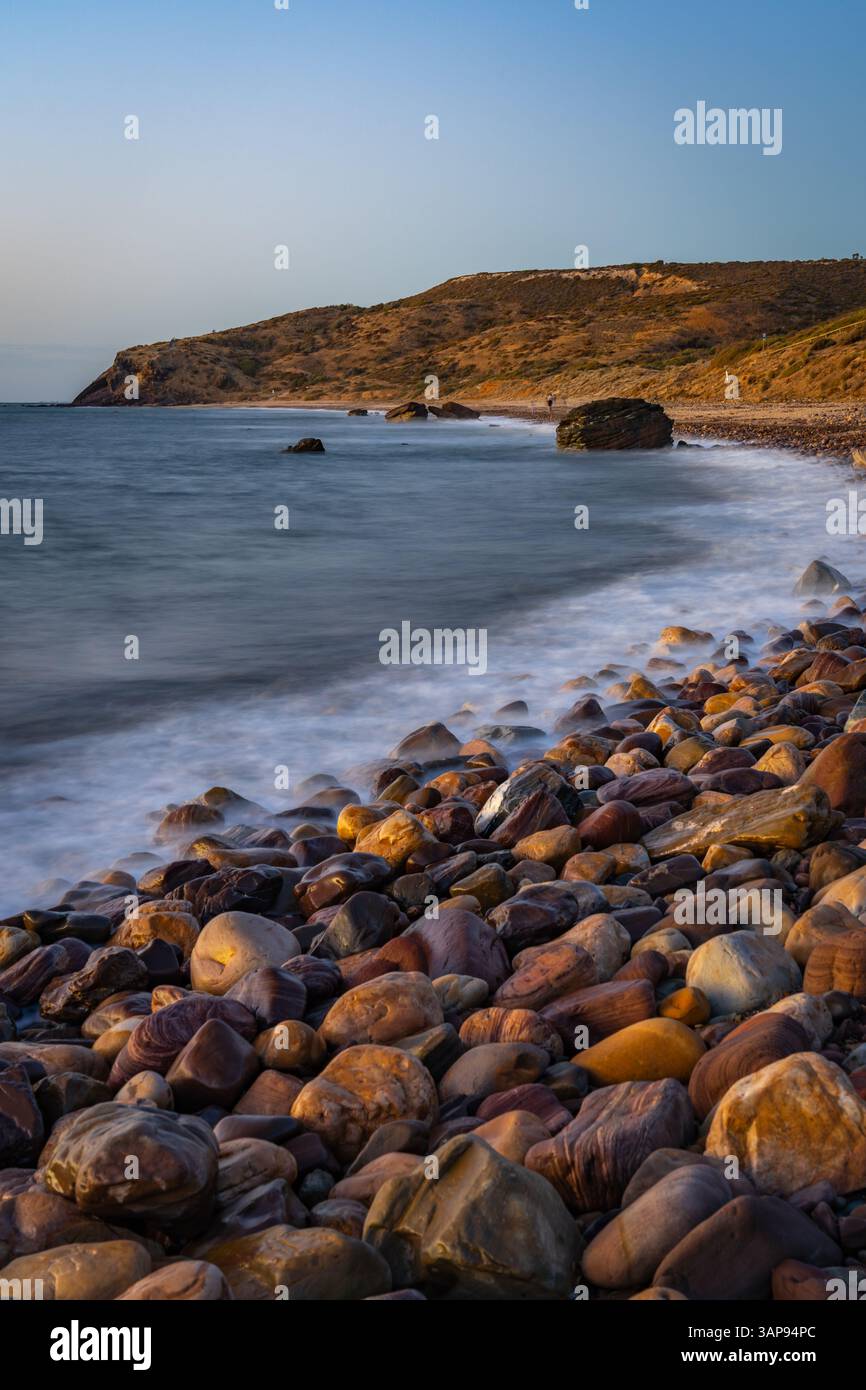 A tranquil coastal scene at sunset at Hallett Cove Beach. Gentle waves ...
