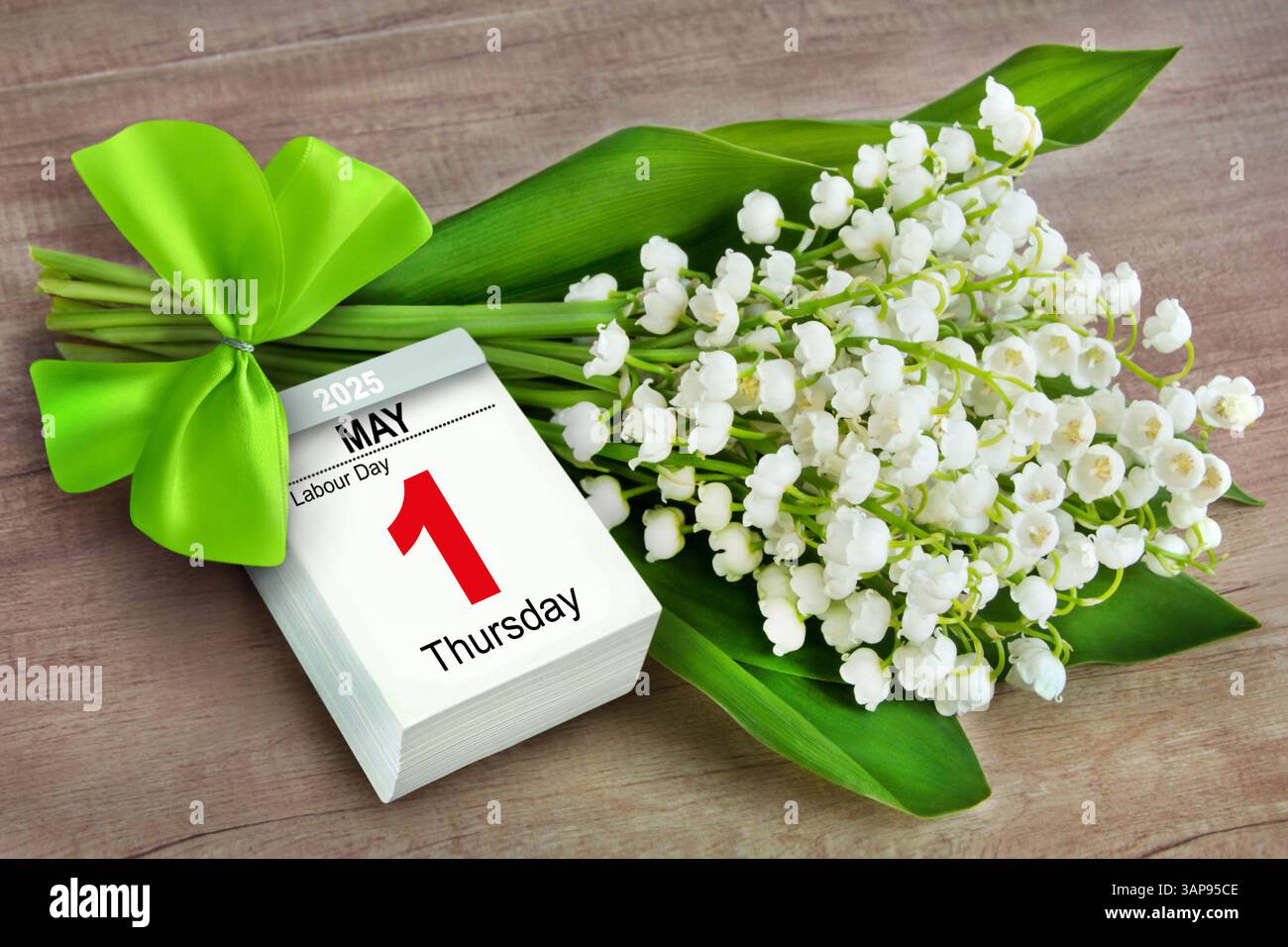Calendar May 1 Thursday 2025 and flowers on wooden backround Labour Day ...