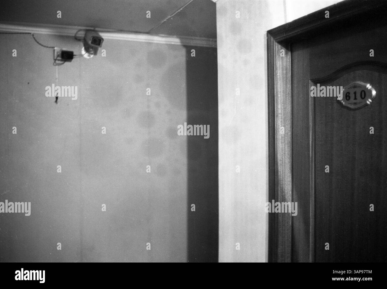 Surveillance and Thresholds: Security Camera Outside Room 610 in a ...