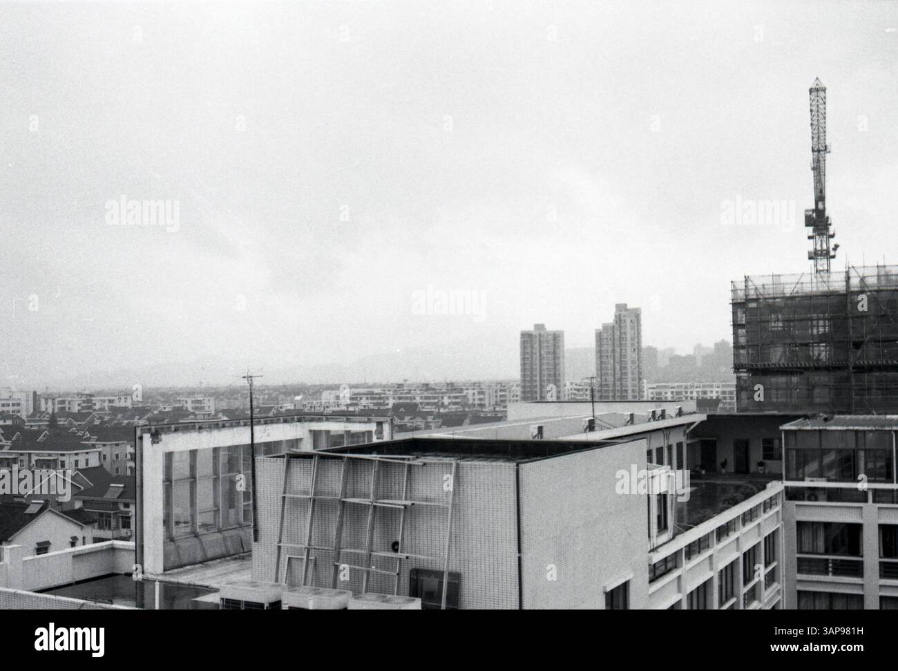 Urban Expansion and Construction Crane over Mid-Rise Buildings ...