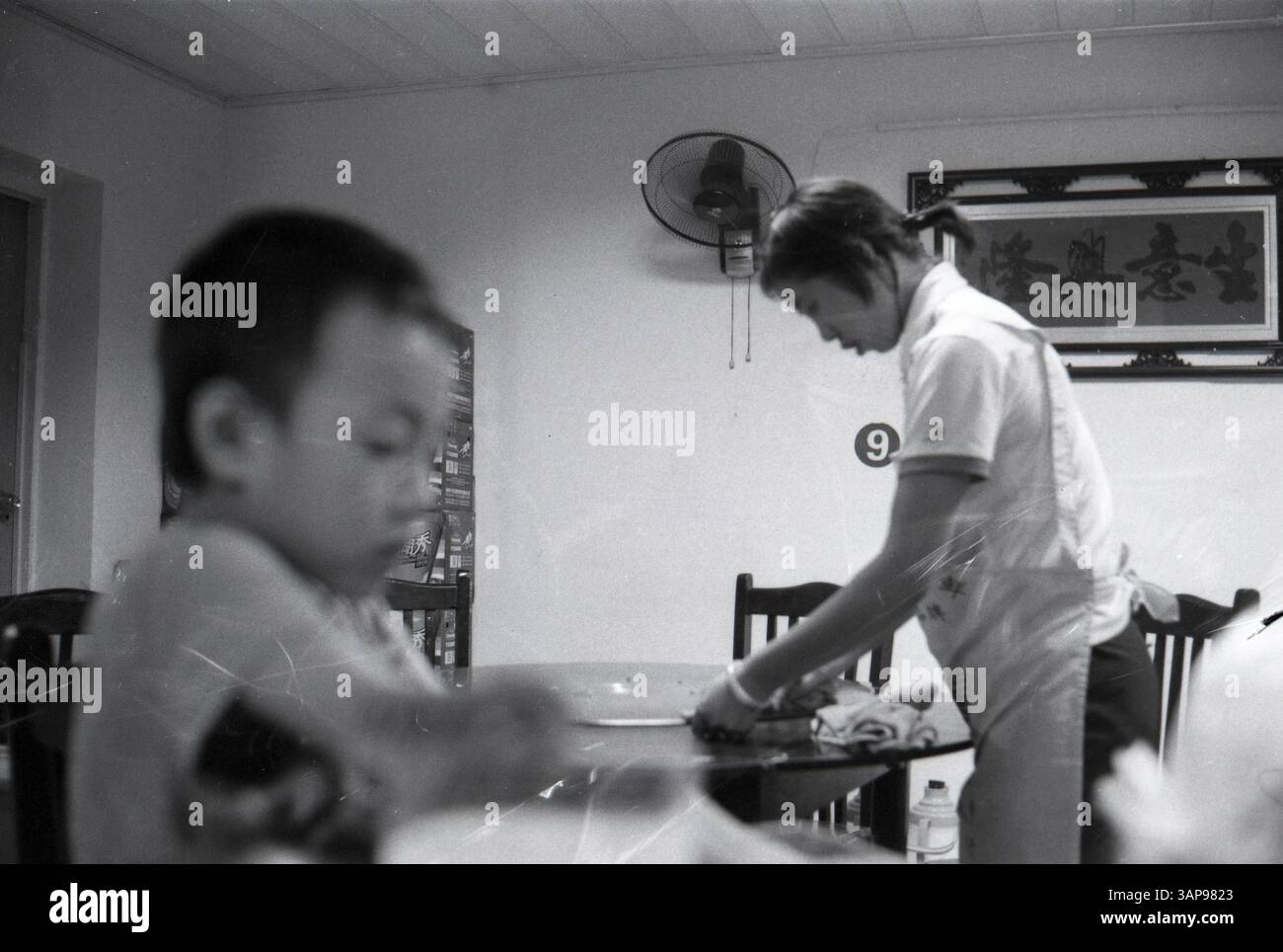 Waitress Cleaning Table in Small Chinese Restaurant - Everyday Dining ...