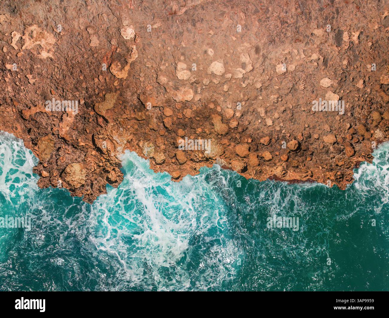 Ocean Waves Crashing Against Rocky Cliffs Along a Coastal Beach ...