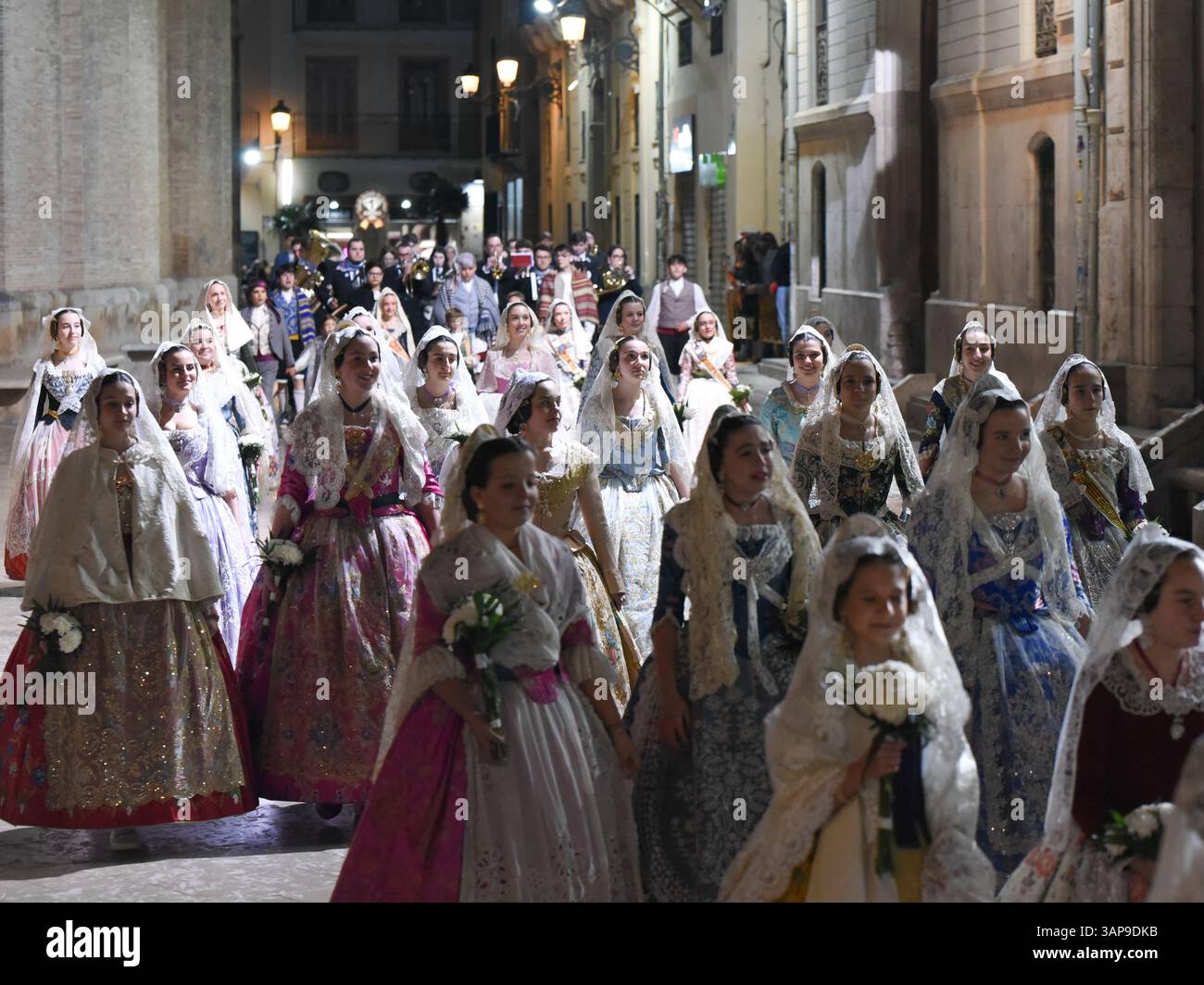 Falleras and believers in period costume walk in procession during ...