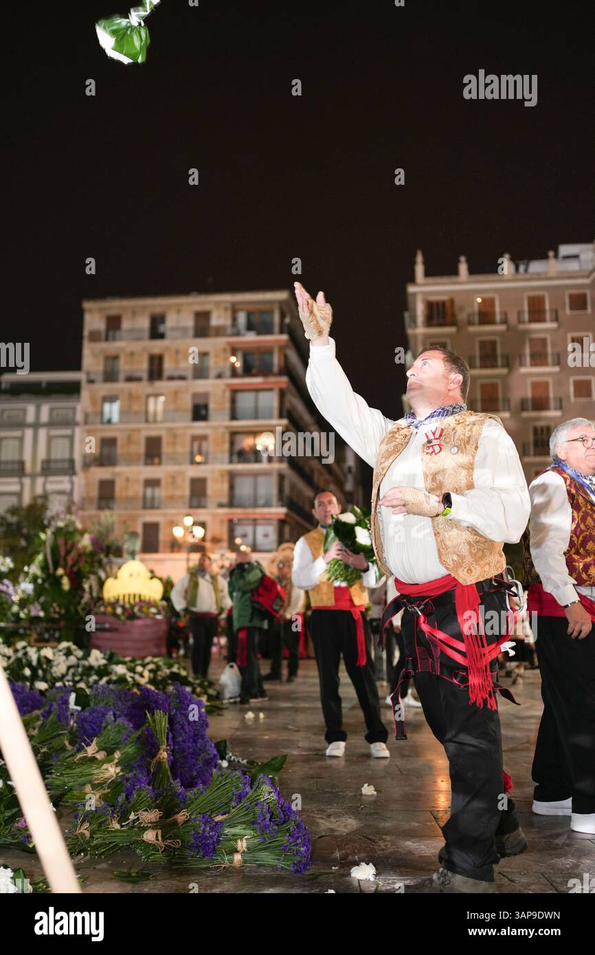 Men in traditional costume climbed on a giant wooden structure ...
