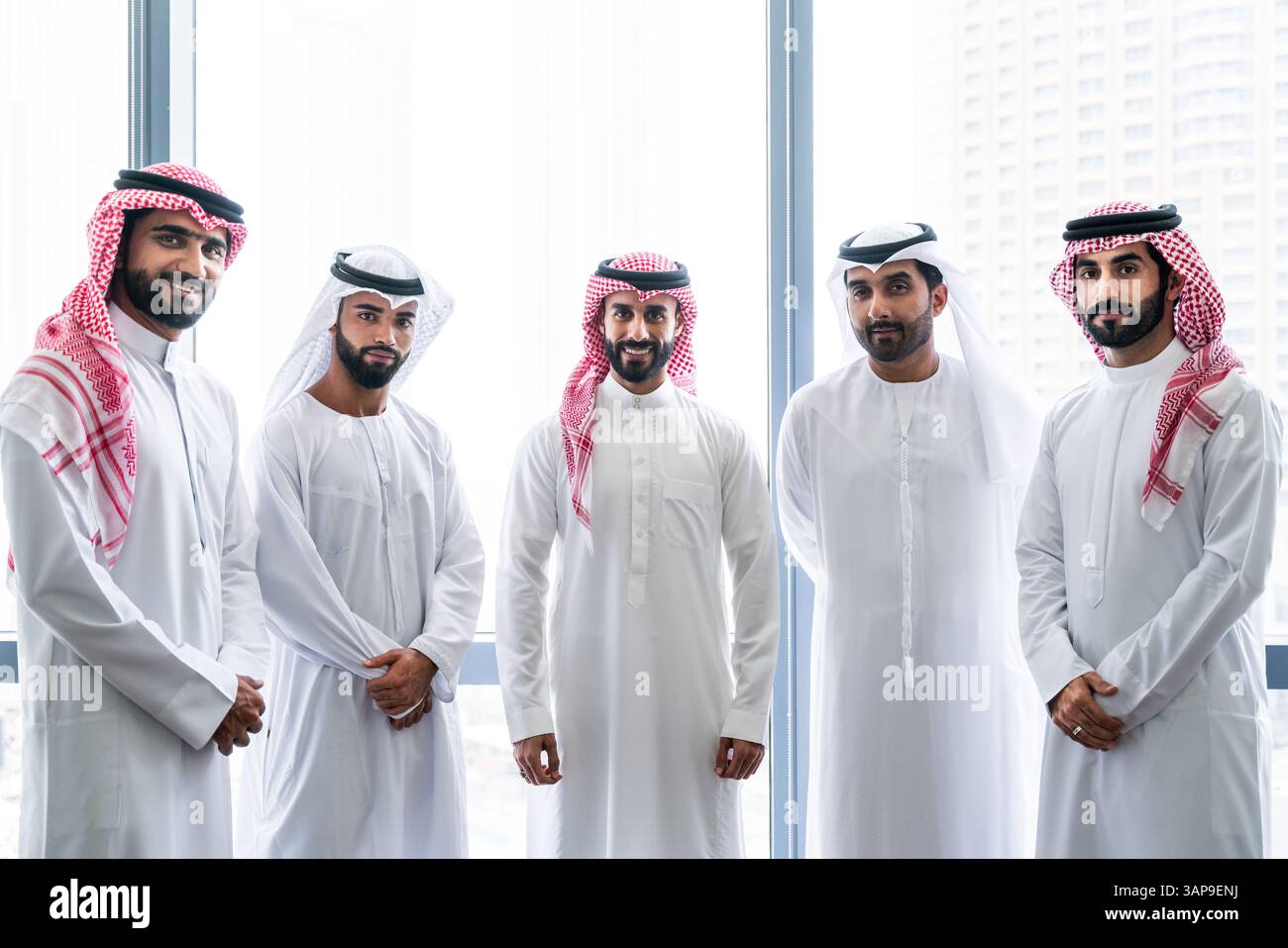 Arab businessmen wearing emirati and saudi kandura meeting in office ...