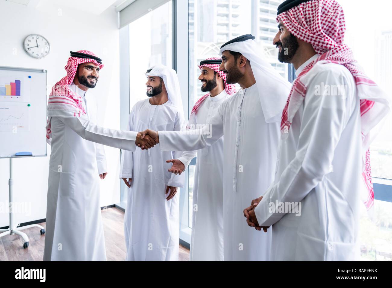 Arab businessmen wearing emirati and saudi kandura meeting in office ...