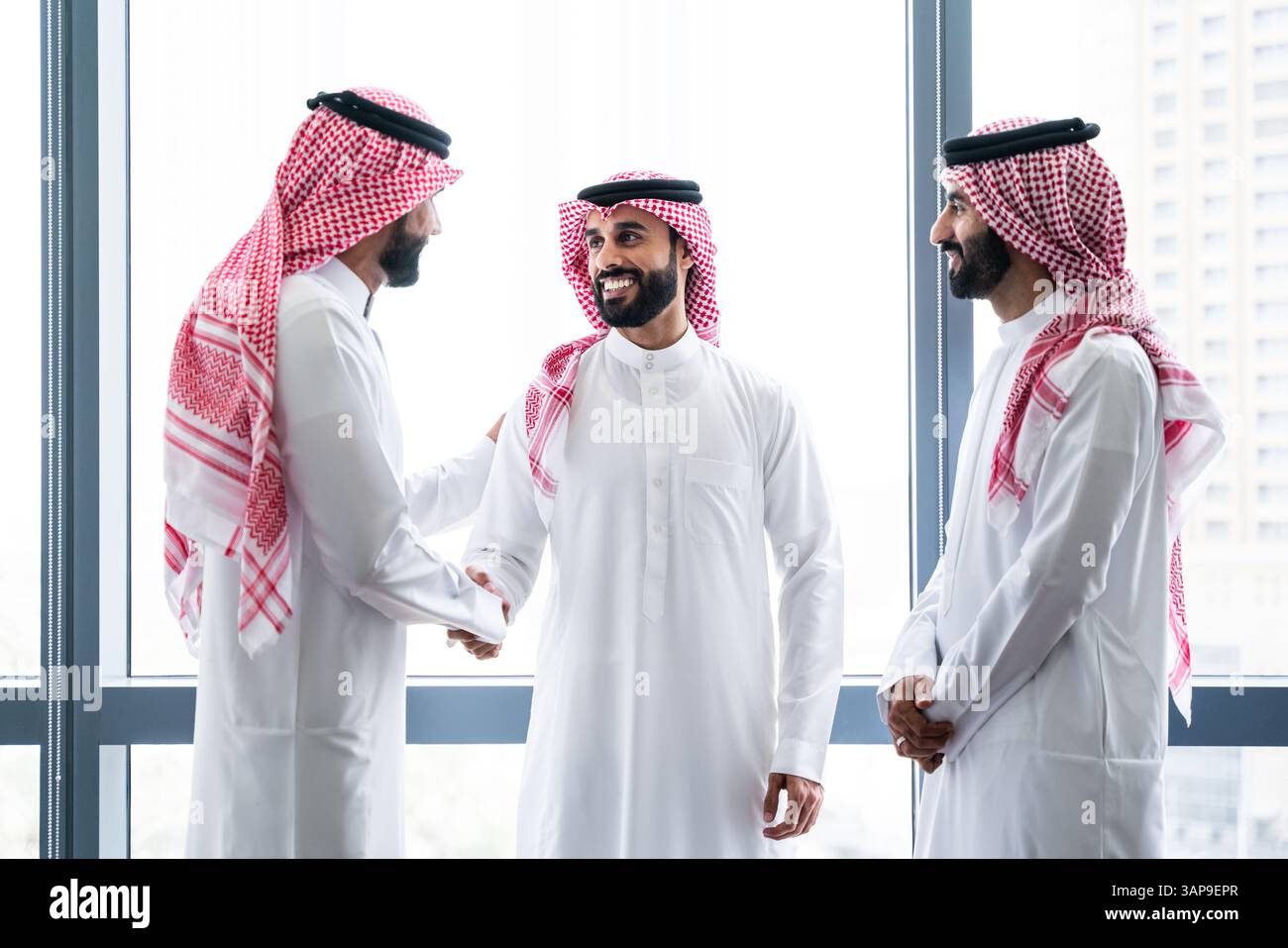 Arab businessmen wearing saudi kandura meeting in office for business ...