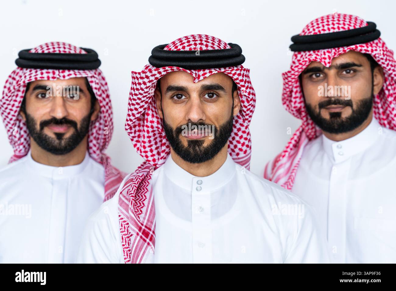 Arab businessmen wearing saudi kandura meeting in office for business ...