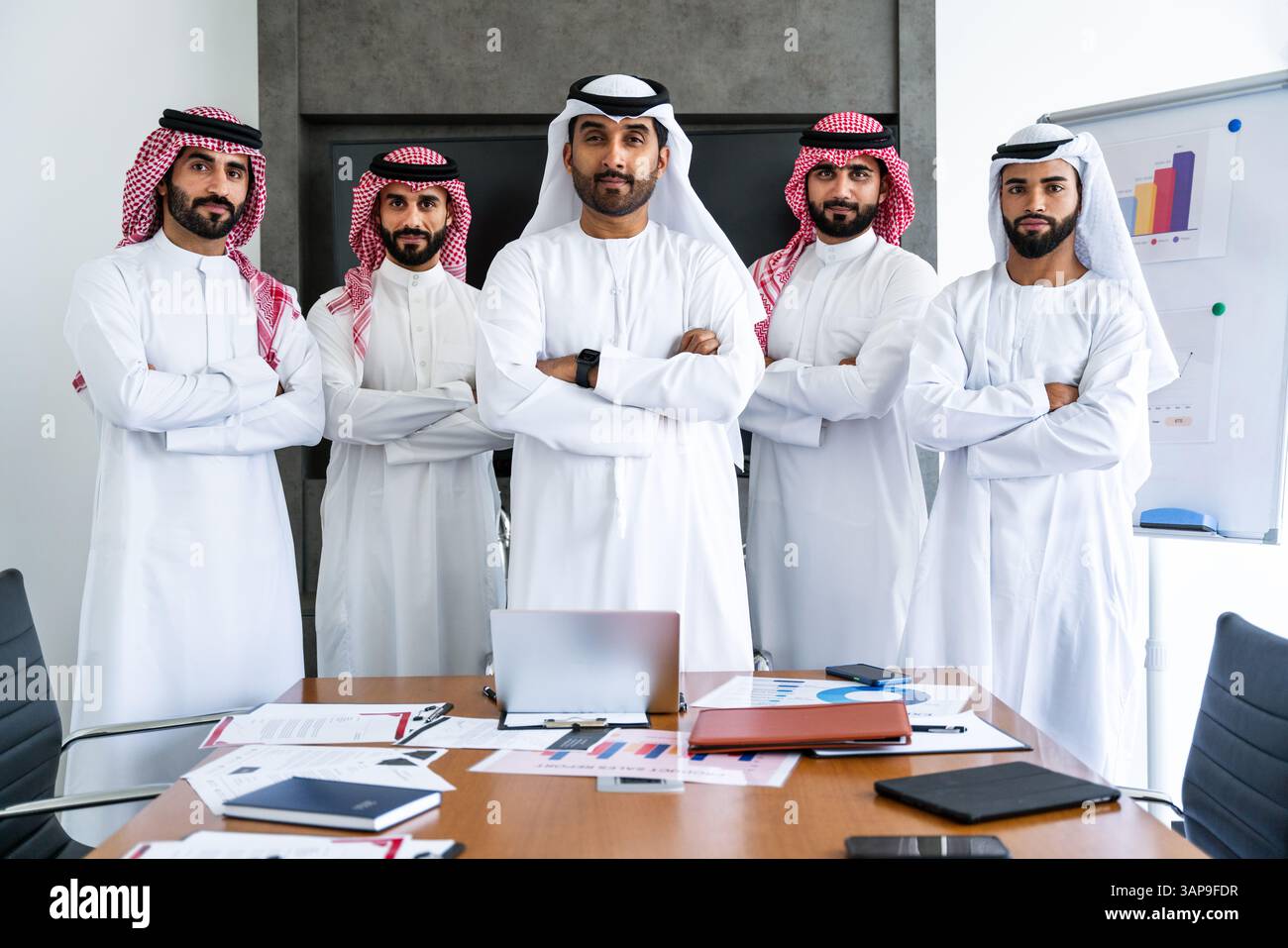 Arab businessmen wearing emirati and saudi kandura meeting in office ...