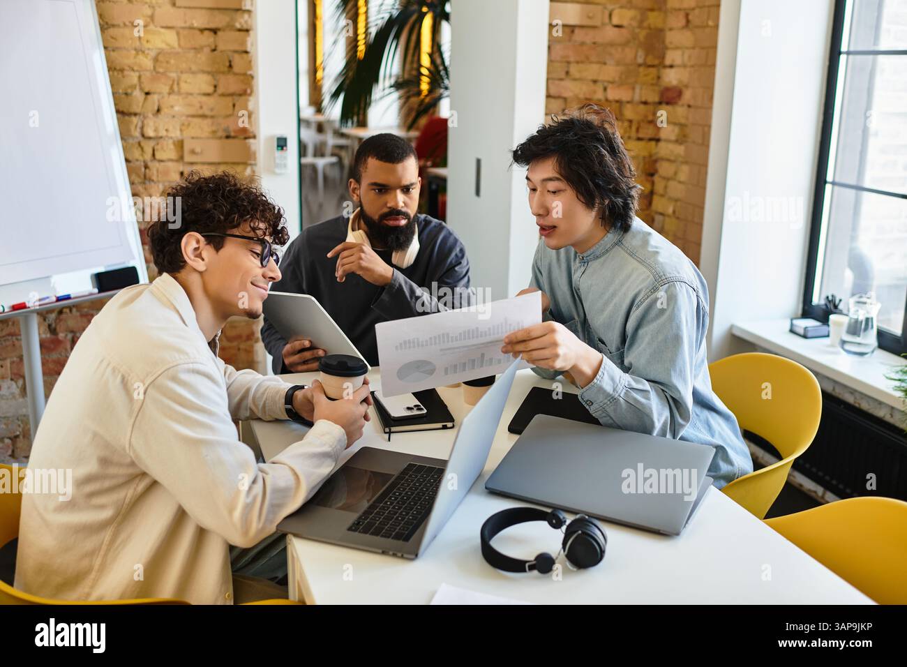 Diverse work colleagues exchanging documents hi-res stock photography ...