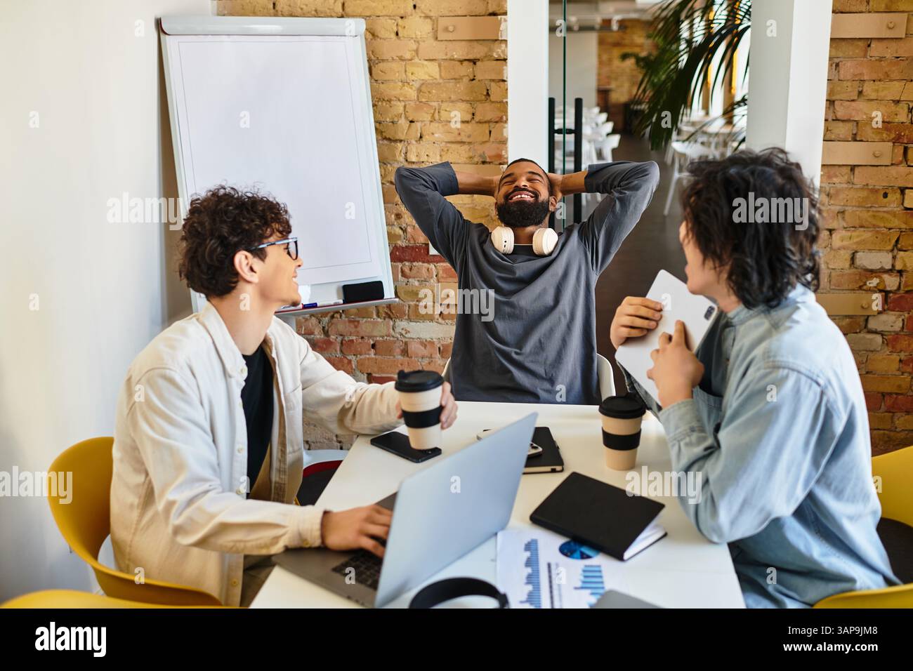 Group of colleagues engaging in a lively discussion while enjoying ...