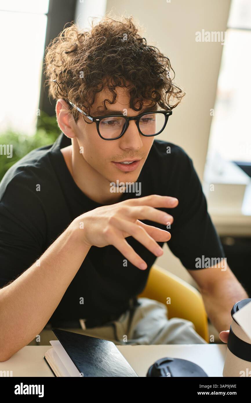 A thoughtful young man shares ideas while collaborating in an inviting ...