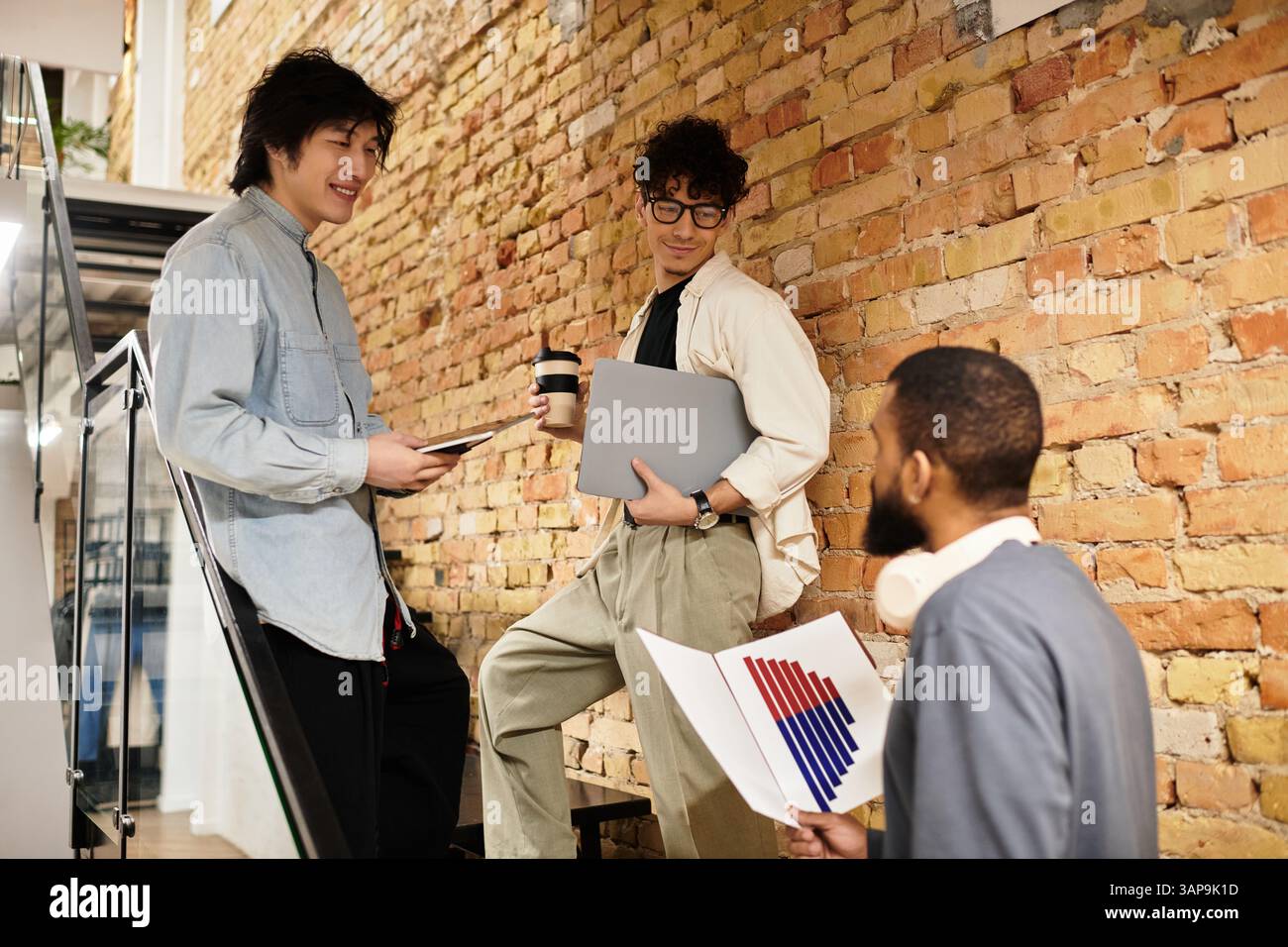 Three team members collaborate in a vibrant office, sharing ideas over ...