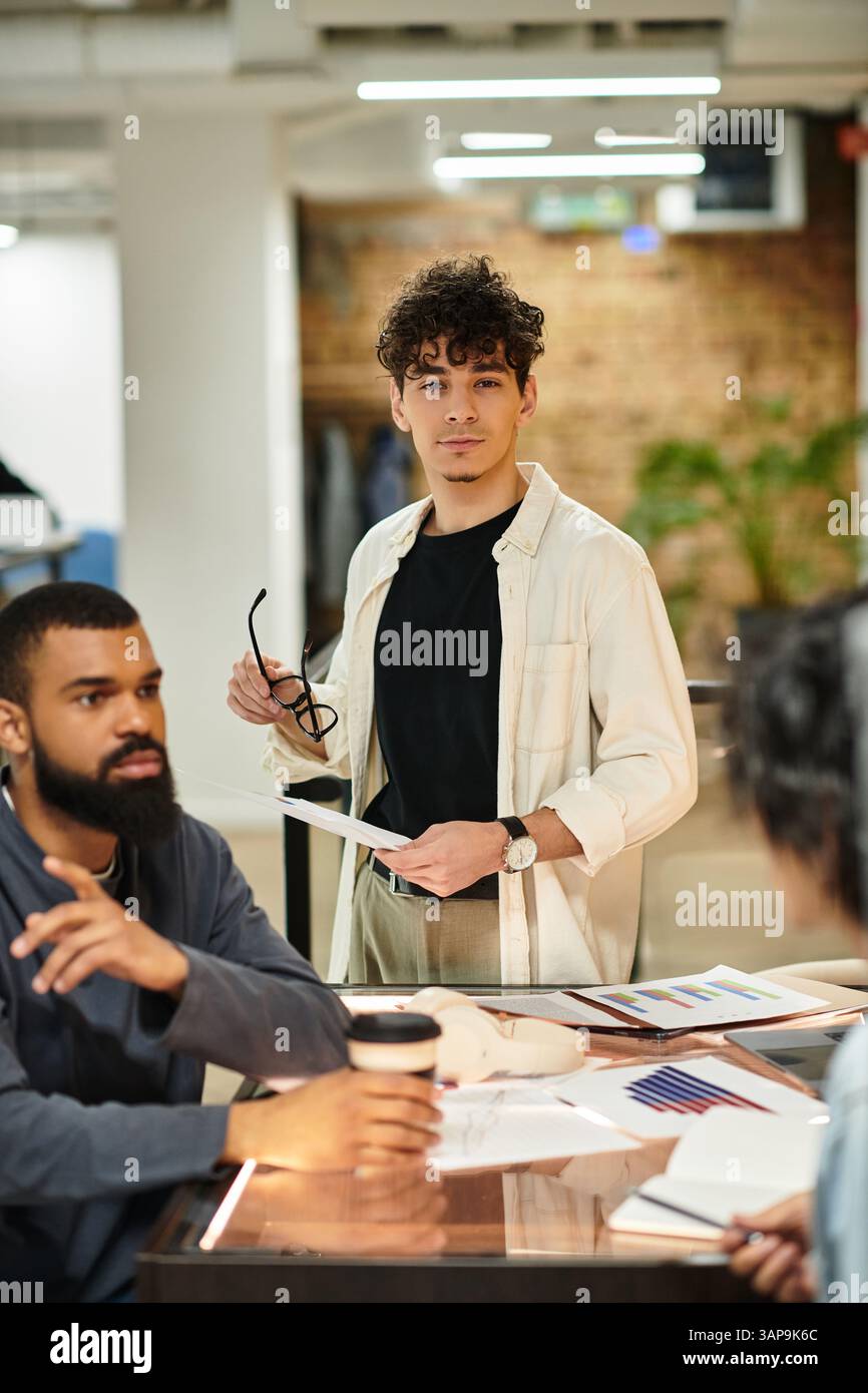 Colleagues actively share ideas while working on a project in a vibrant ...