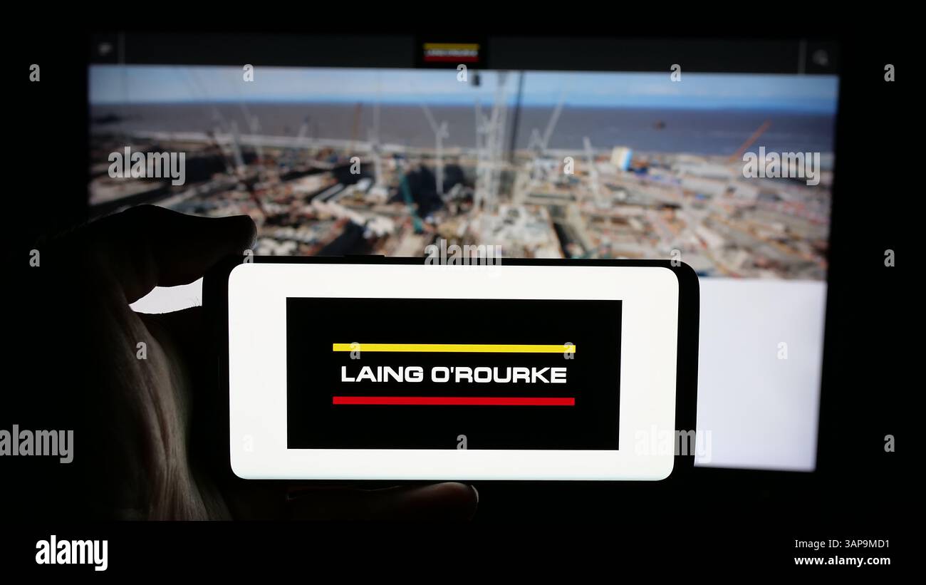 In this photo illustration, a person is holding a cellphone with the logo of British ...