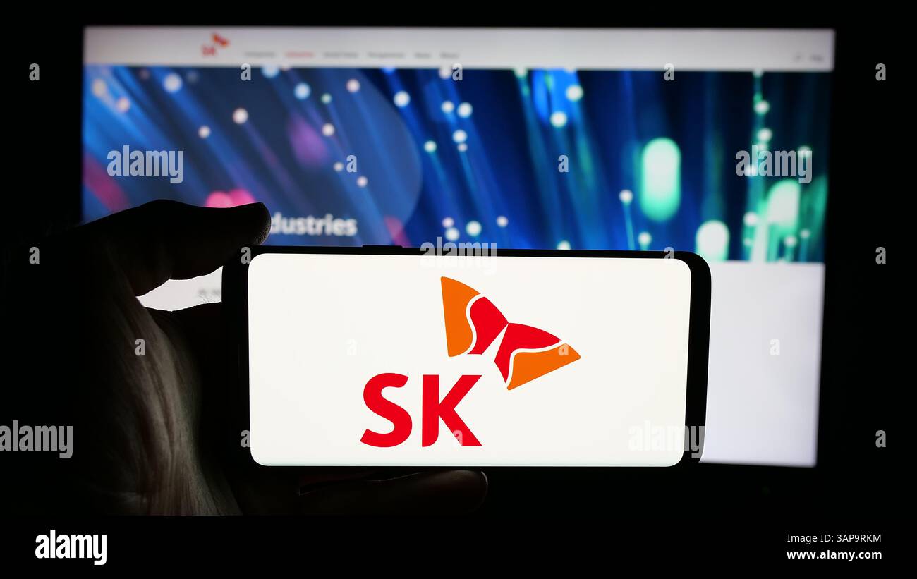 In this photo illustration, a person is holding a cellphone with the logo of South Korean ...