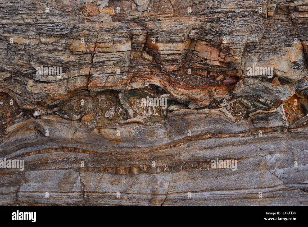 Stratified rock in different layers and materials Stock Photo - Alamy