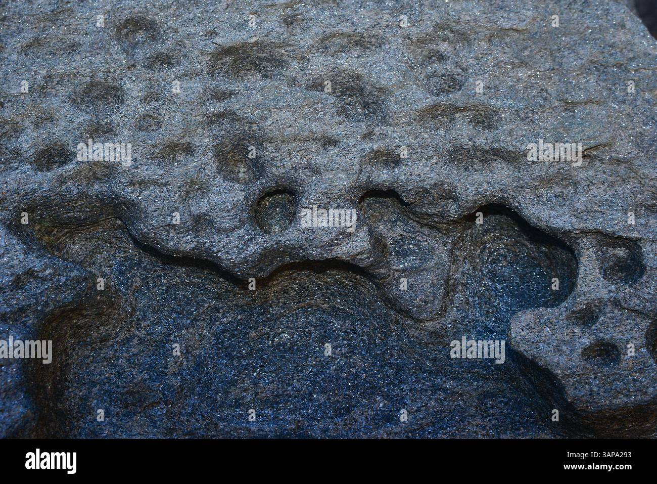 Dark rock with vesicular pores Stock Photo - Alamy
