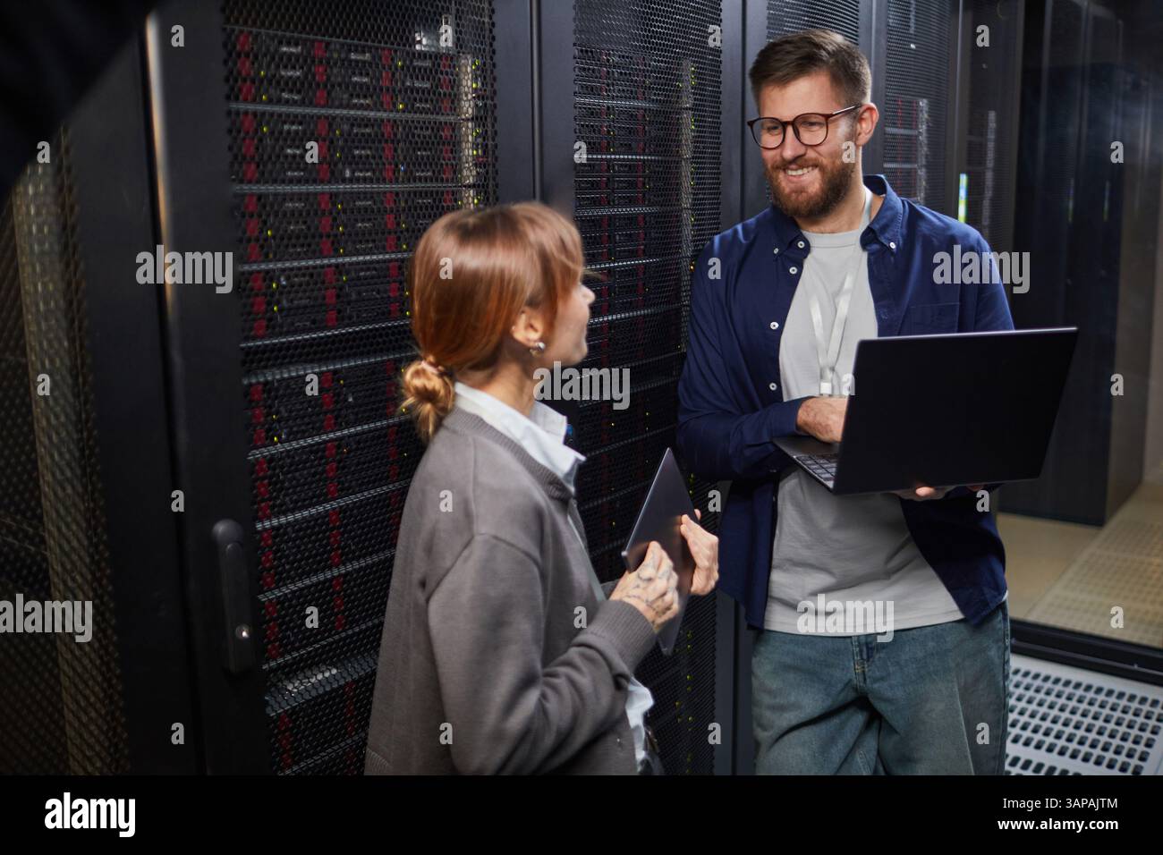 Image showing two IT professionals conversing in modern data center ...