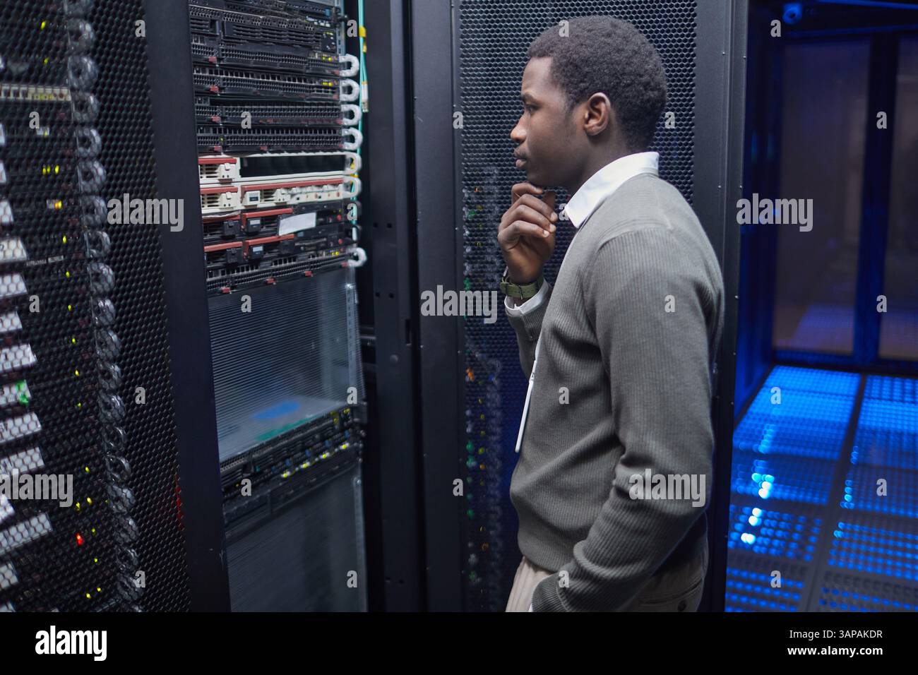 African American technician standing near server racks in data center ...