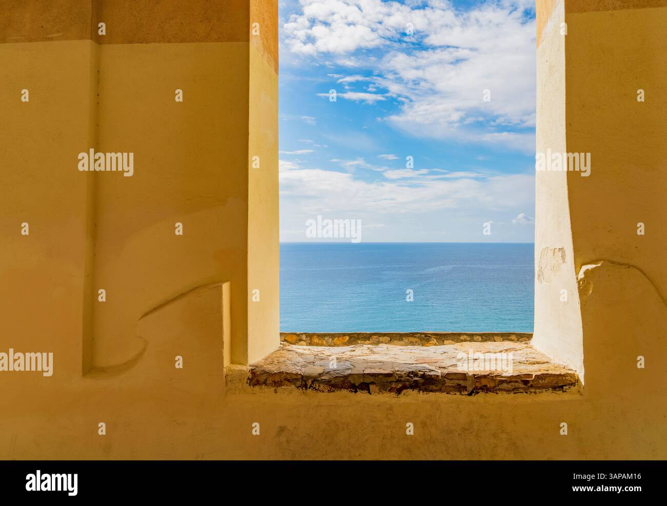 Sunny mediterranean sea scenery seen through a window opening in a ...