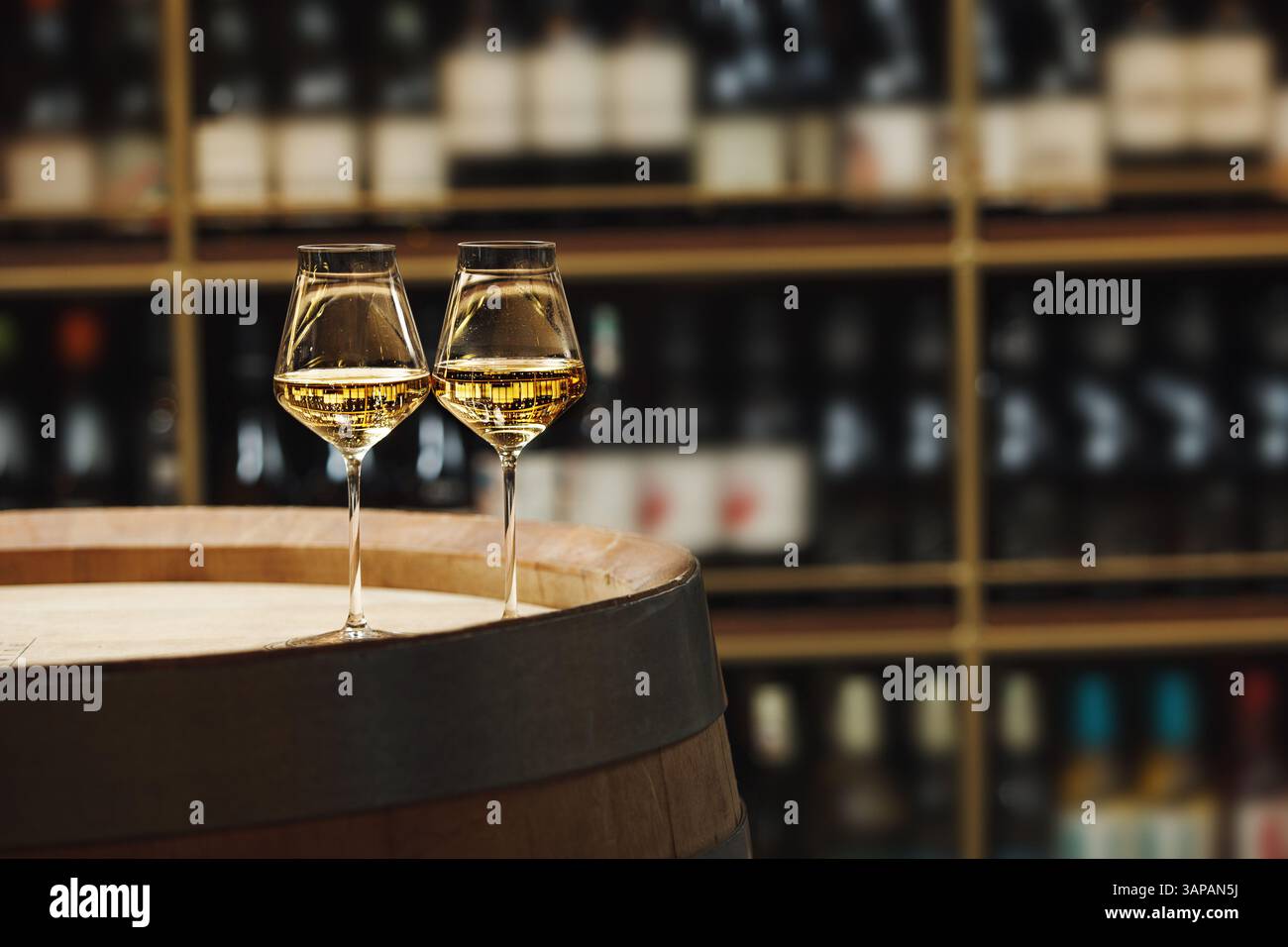 Two Champagne Glasses Resting on Wooden Barrel in Cellar Stock Photo ...