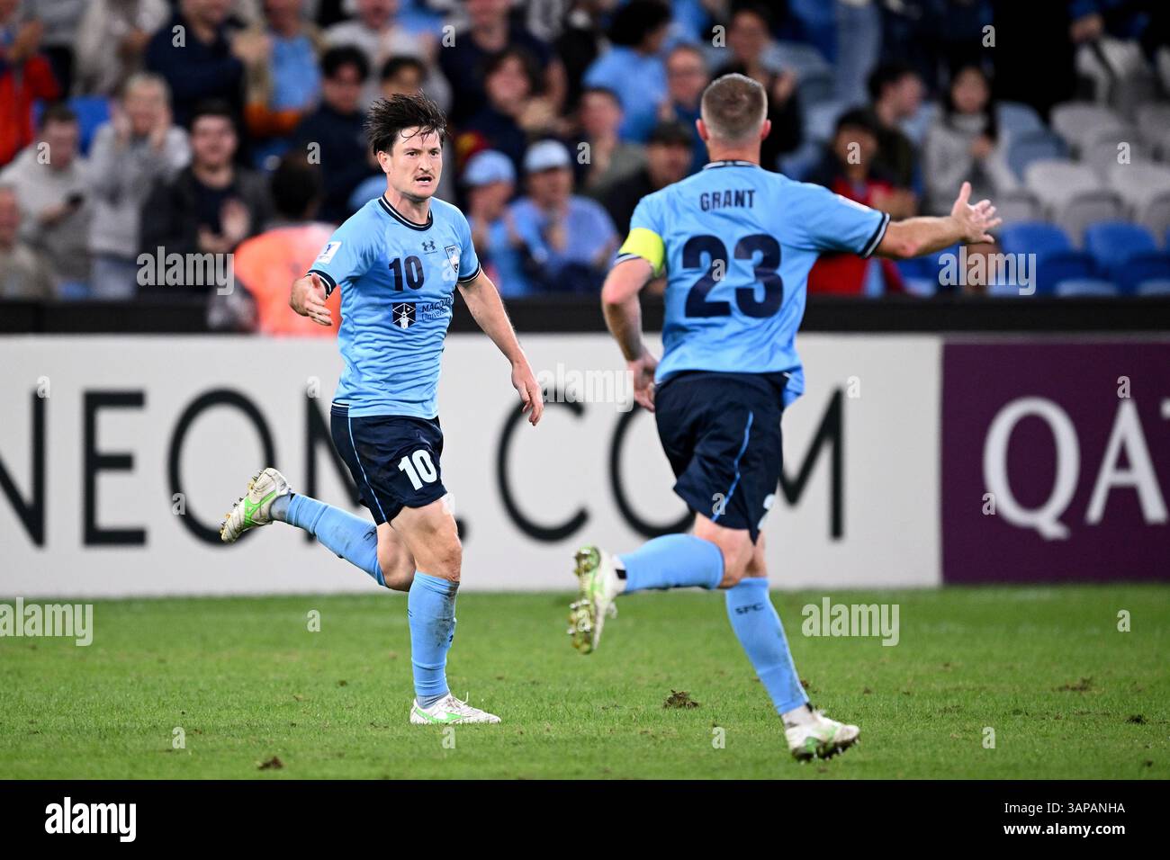 Joe Lolley of Sydney (left) celebrates with Rhyan Grant after scoring a ...
