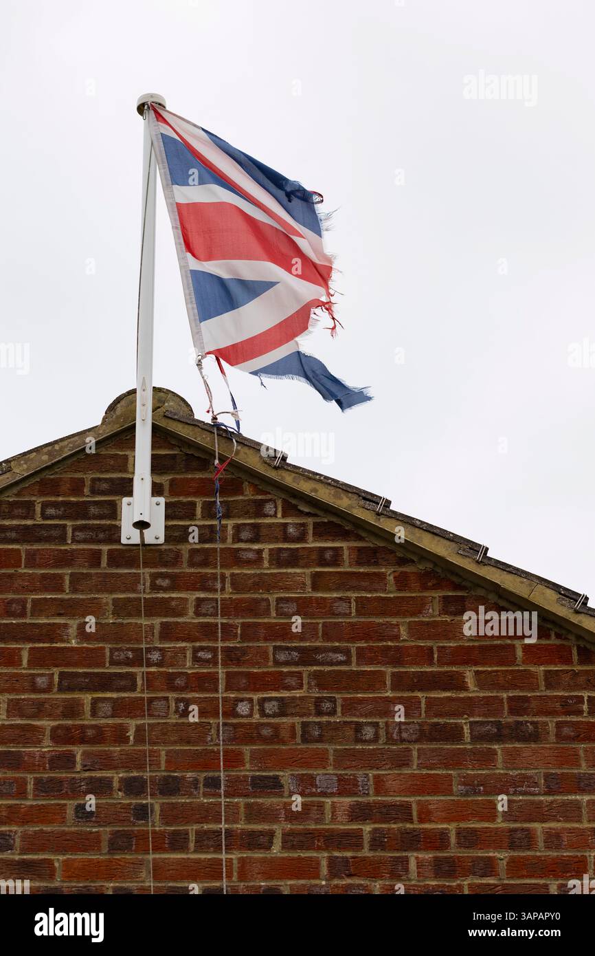 Ripped Union Jack Flag blowing in the wind Stock Photo - Alamy
