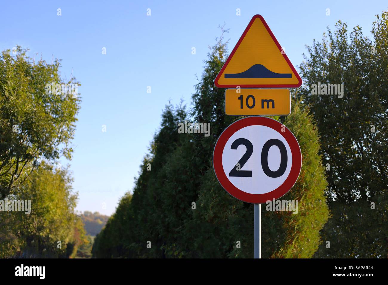 20 kilometers per hour speed limit road sign with speed bump warning ...
