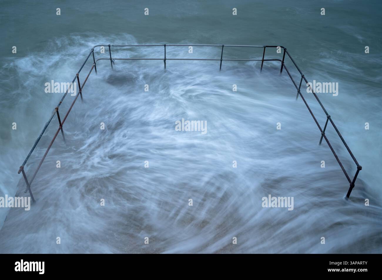 A long exposure picture of waves lapping over the Hotwalls in front of ...