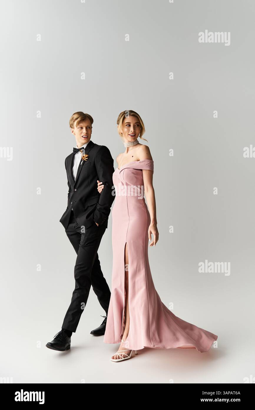 A joyful young couple walks together, radiating love in springtime ...