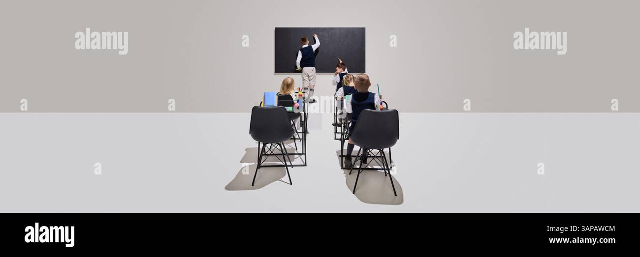 Children standing near blackboard with classmates watching from desks ...