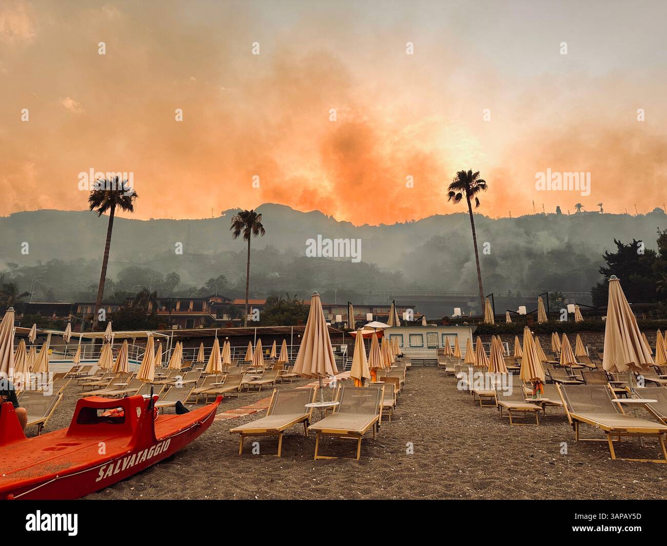 Beachfront Resort Threatened by Raging Wildfire Stock Photo - Alamy