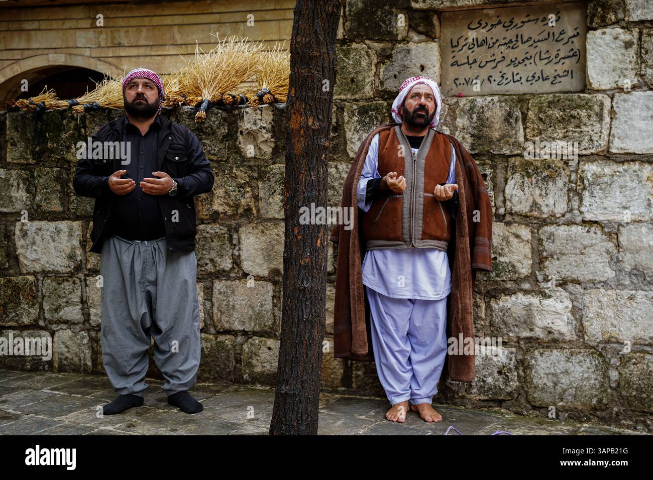 Iraqi Yazidi men pray at Lalish mountain valley and temple near the ...