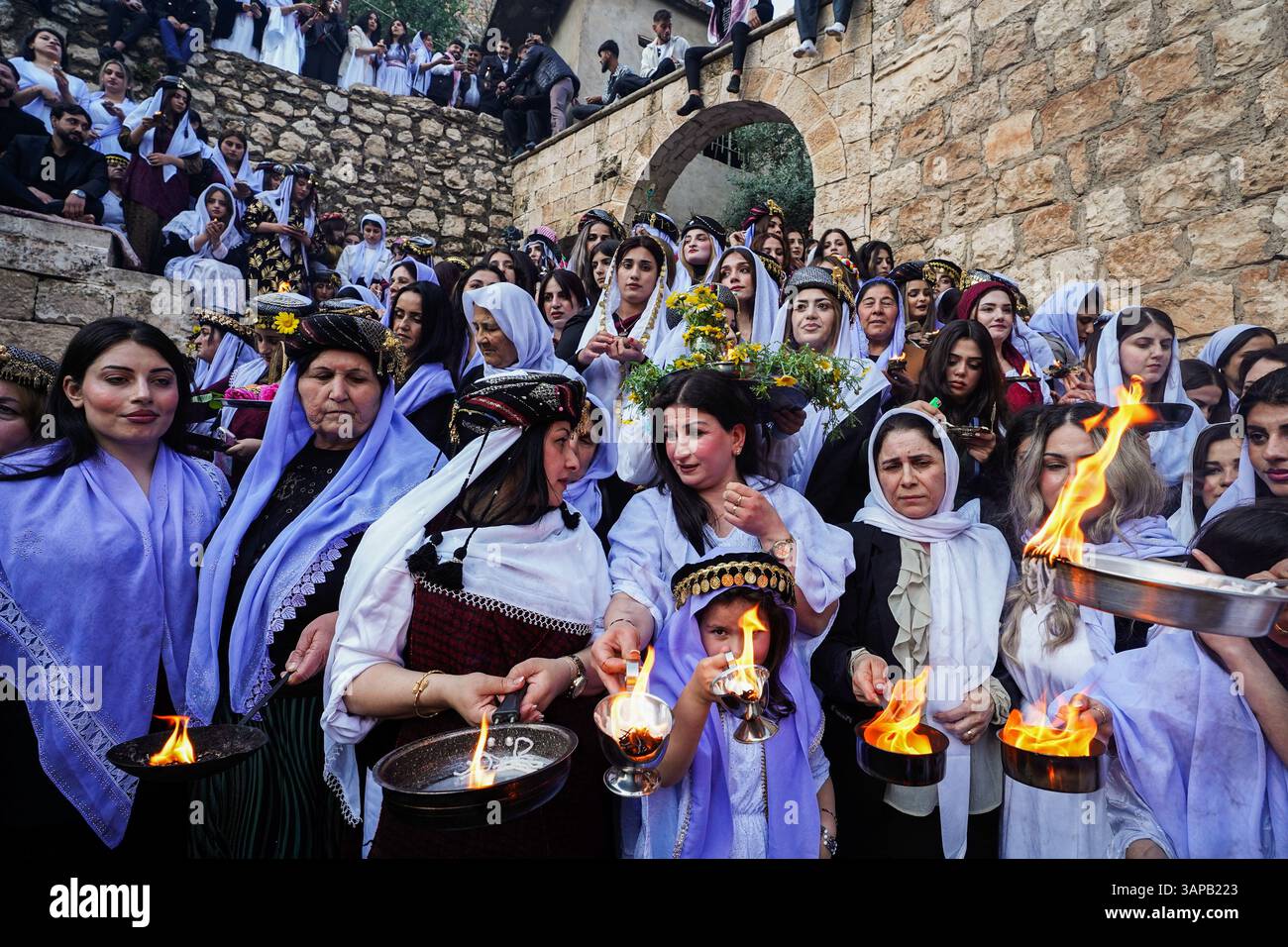 Lalish, Iraq. 15th Apr, 2025. Iraqi Yazidi women light candles at ...