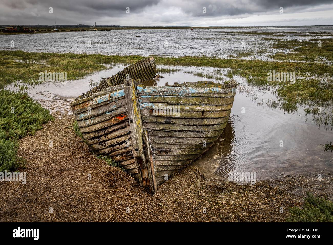 Abandoned fishing boat, broken and eroded by the weather and tides at ...