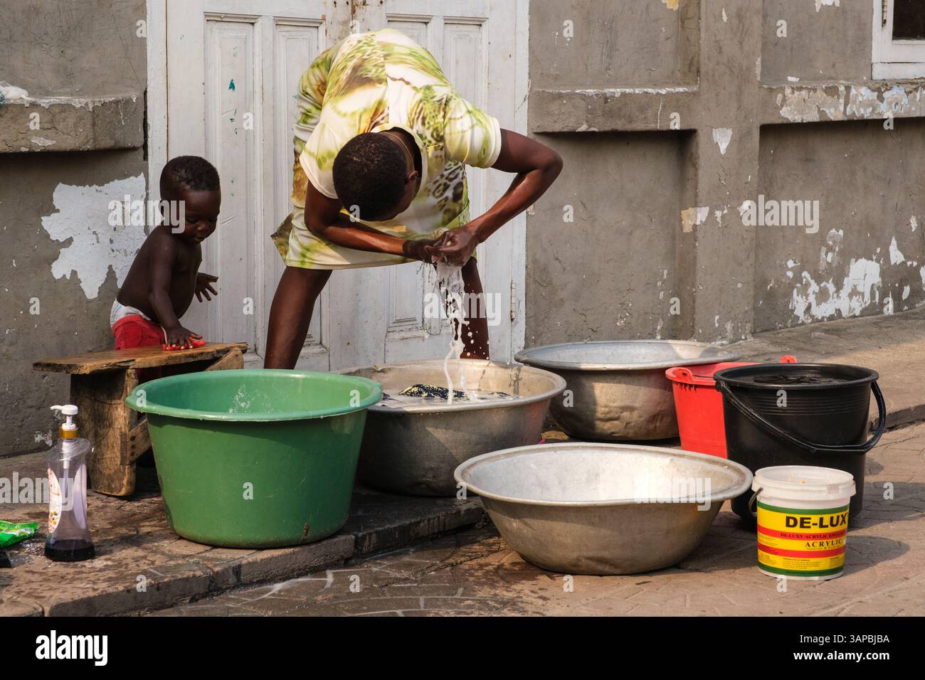 Accra, Ghana. Jamestown Neighborhood, Woman Washing Clothes in ...
