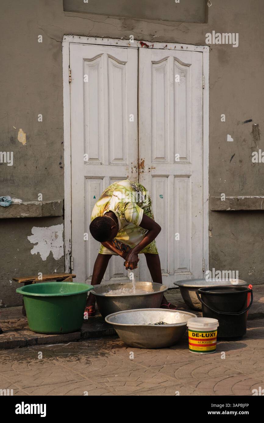 Accra, Ghana. Jamestown Neighborhood, Woman Washing Clothes in ...