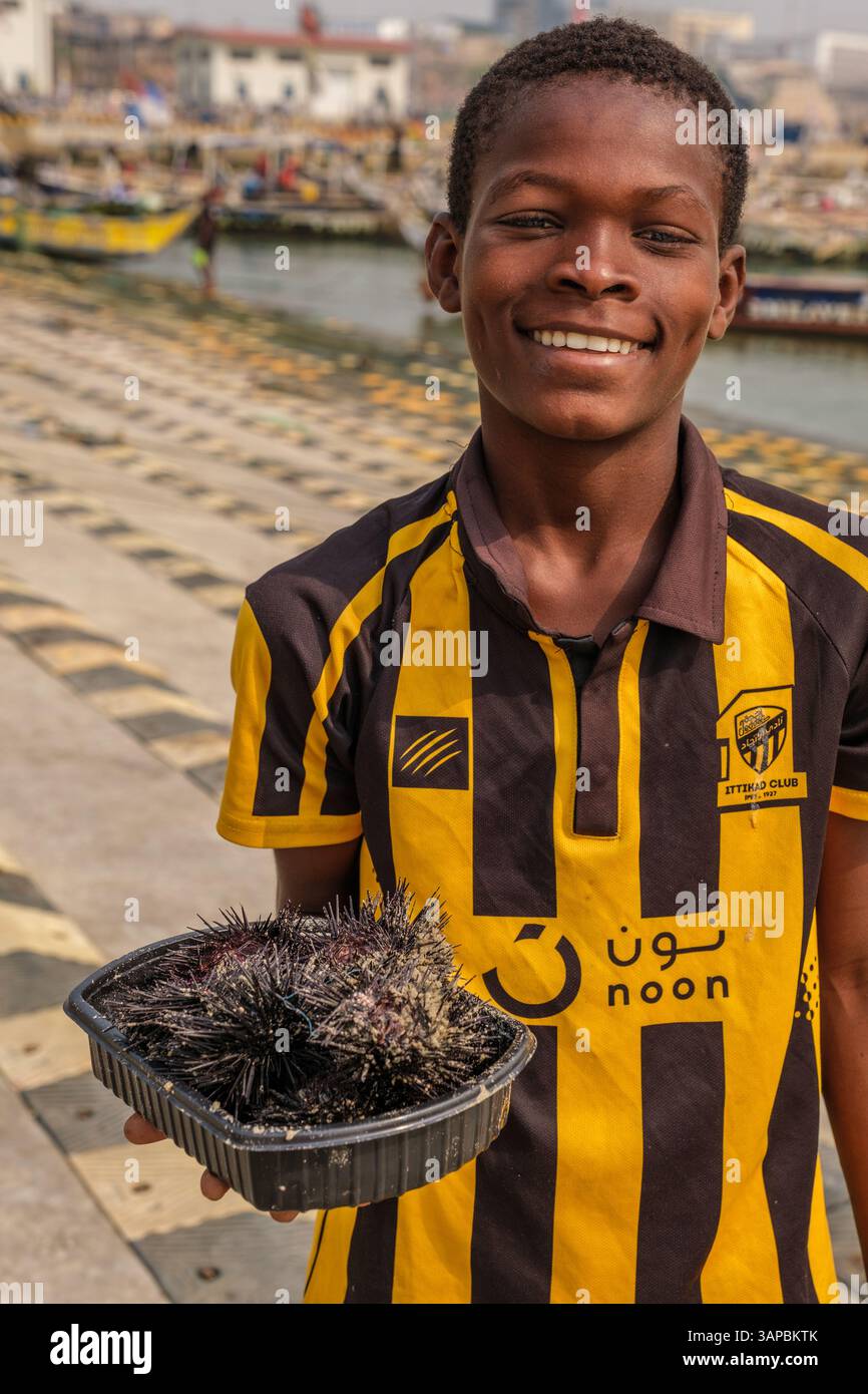 Accra, Ghana. Jamestown Fishing Harbor. Young Man Offering Sea Urchins ...