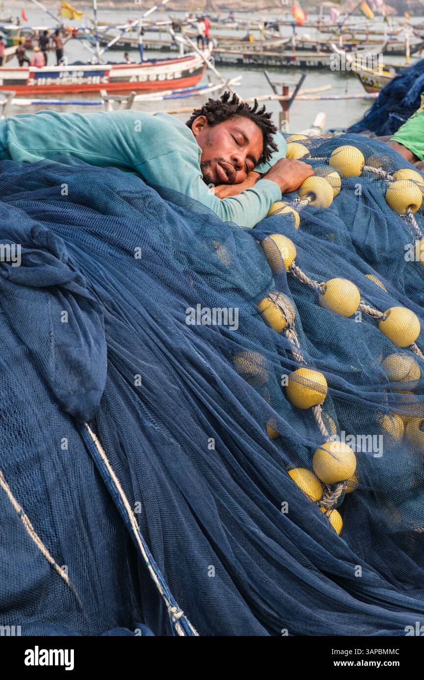 Accra, Ghana. Jamestown Fishing Harbor. Fisherman Sleeping on his Nets ...