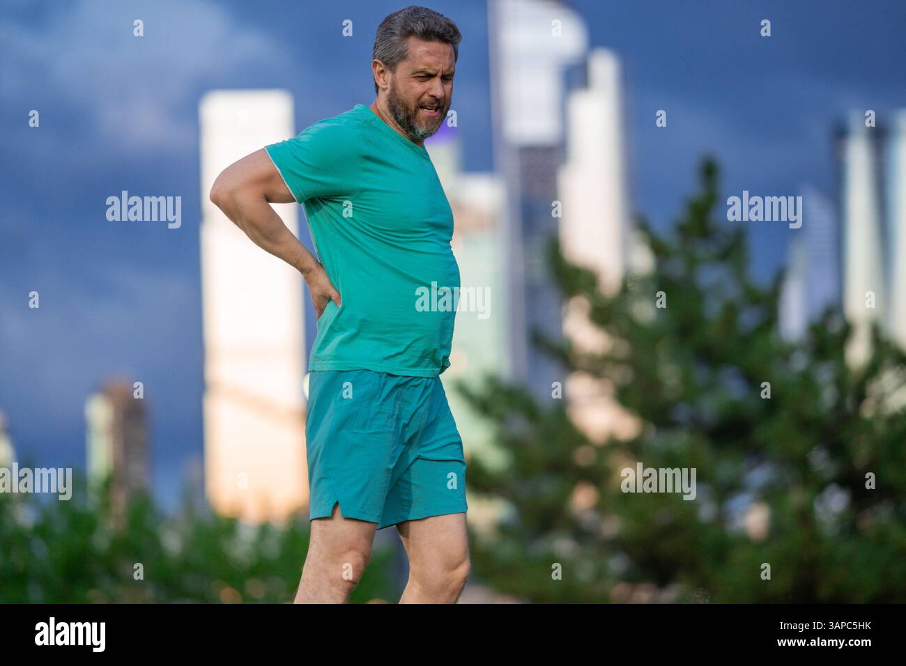 Mature sport man feeling back pain. Trouble with sore muscles. Sports ...