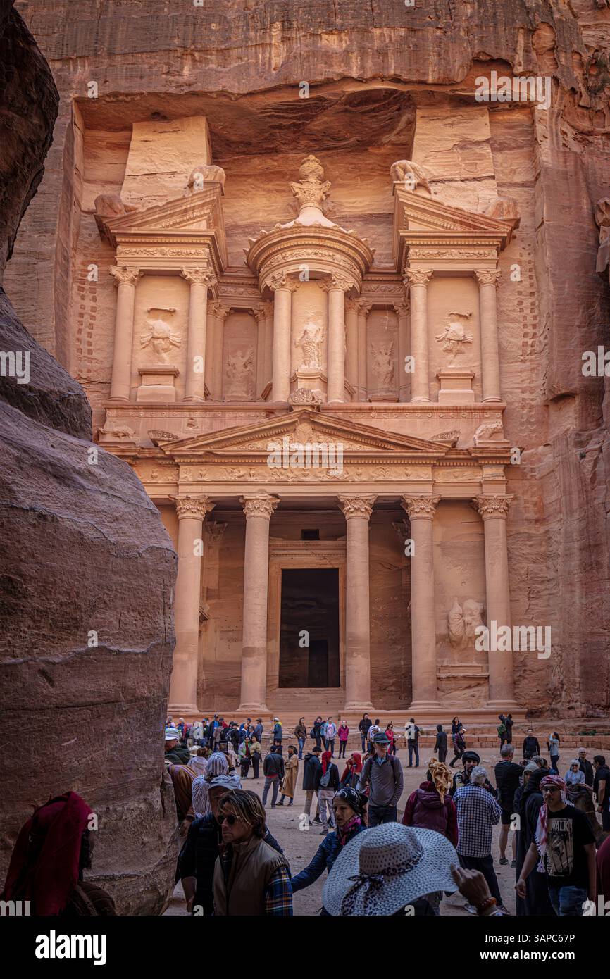Tourists visiting the treasury at petra, jordan, a unesco world ...
