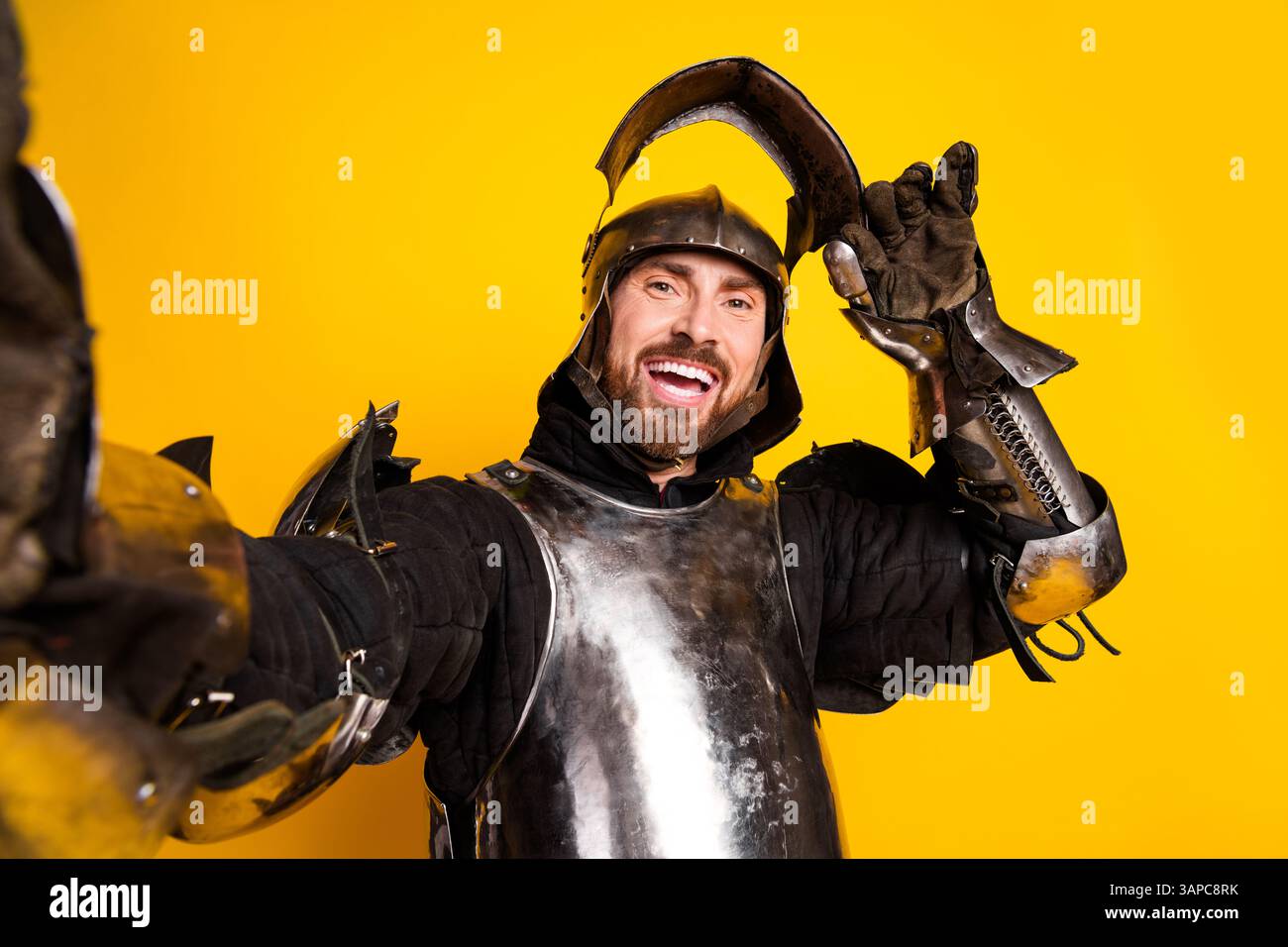 Dynamic young man in medieval knight armor posing against a vibrant ...