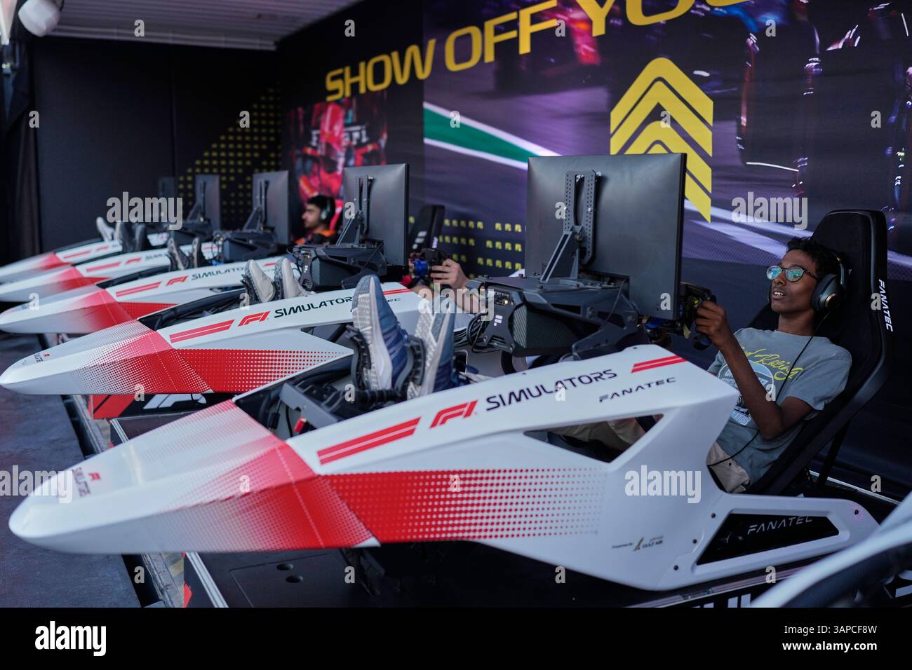 F1 fans try out race simulators at the Formula One Bahrain Grand Prix ...